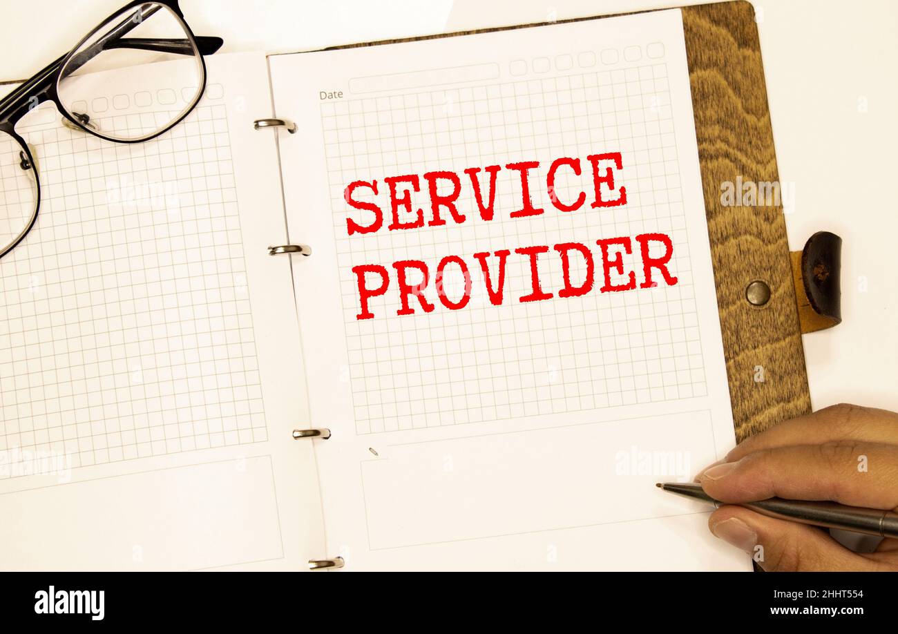 On a light wooden background, a colored pencil and a white sheet of ...