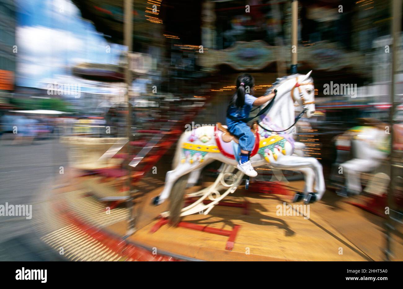 Girl riding on merry go round hi-res stock photography and images - Alamy