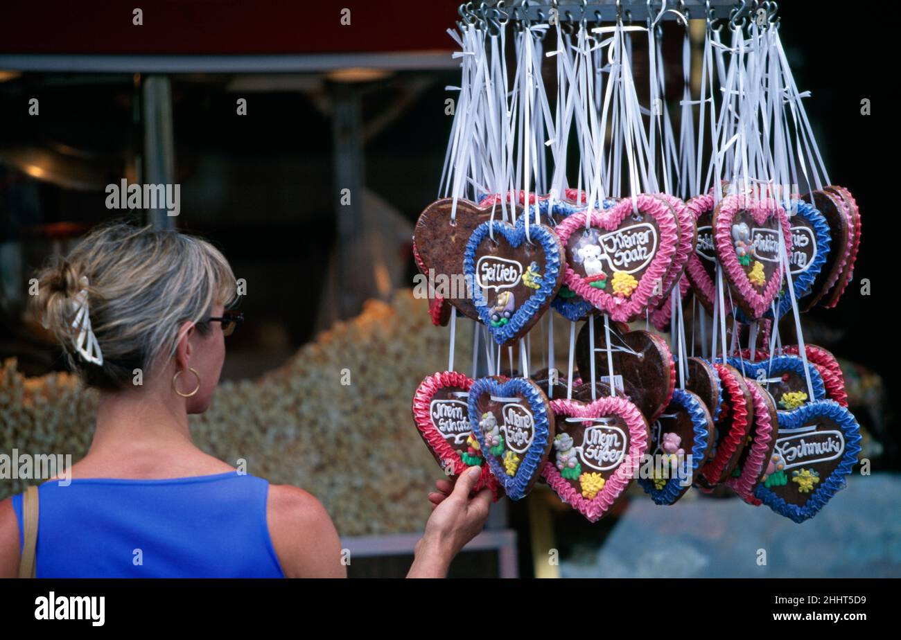 A young woman holding heart shaped traditional German Lebkuchen ...