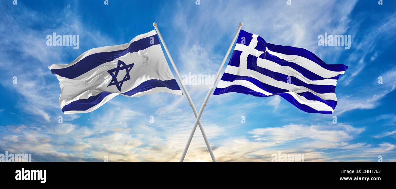 crossed national flags of Israel and Greece flag waving in the wind at ...