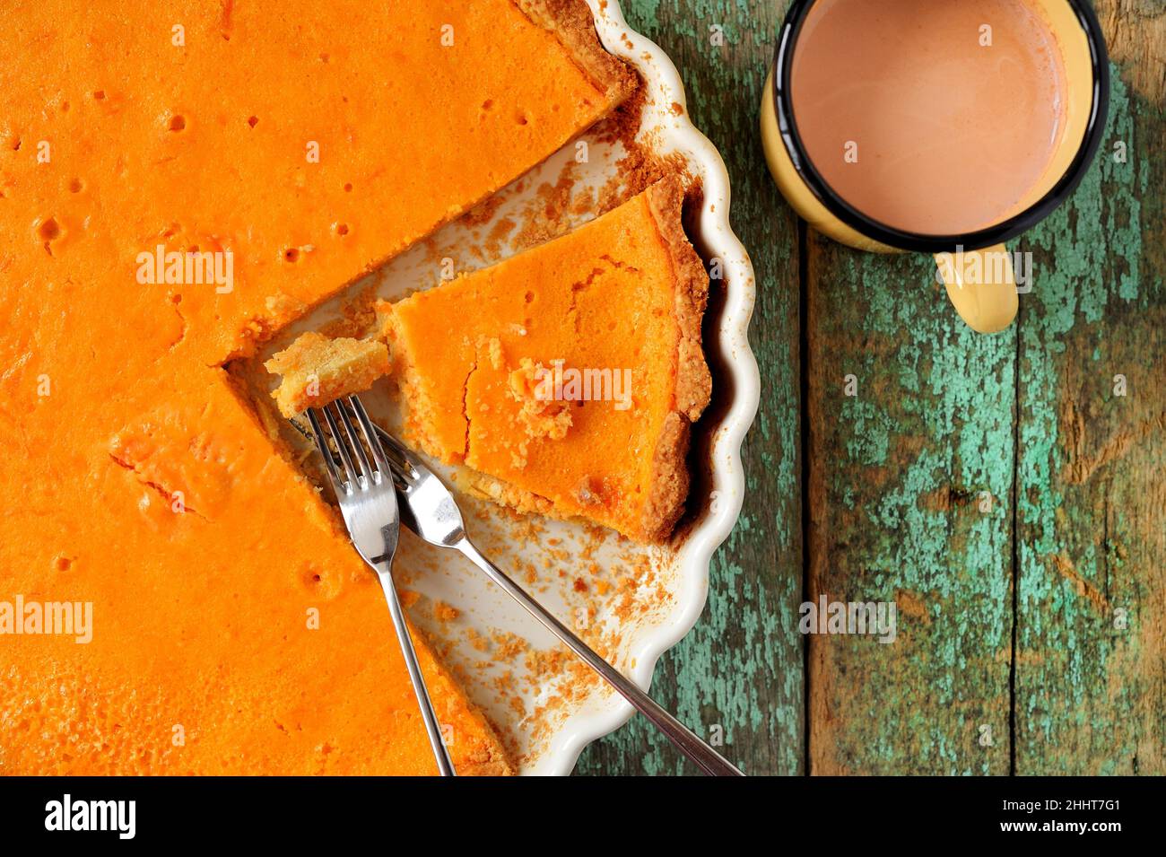 Fresh round bright orange homemade pumpkin pie in white baking dish ...