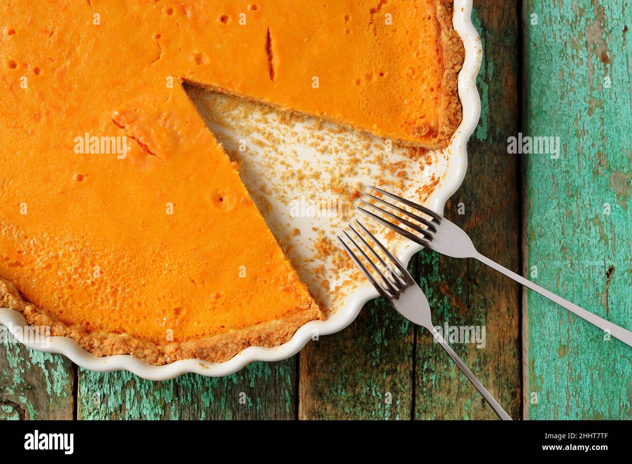 Fresh round bright orange homemade pumpkin pie in white baking dish ...