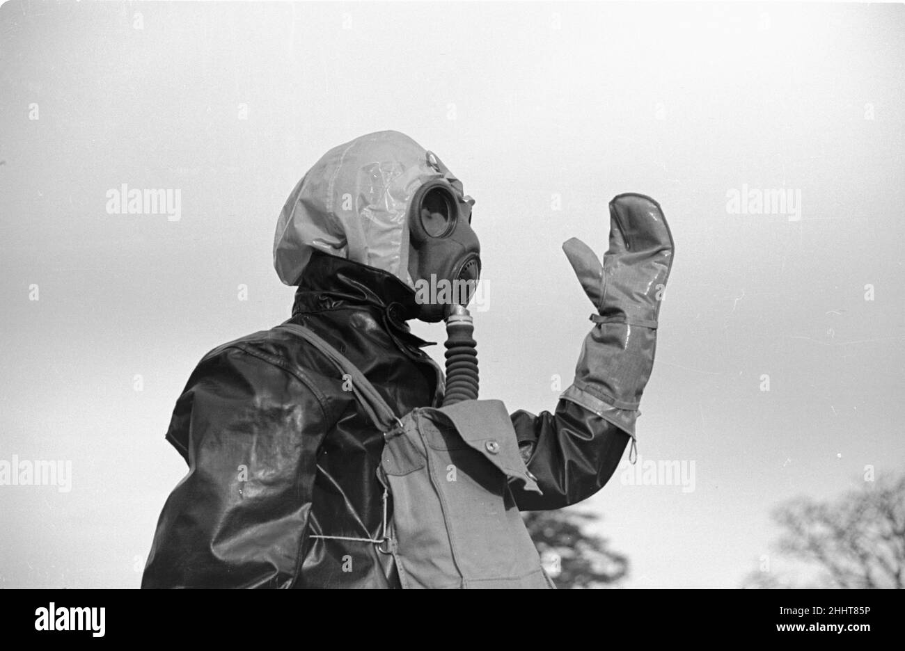 Preparations for war. ARP warden gets use to his gas mask and coat ...