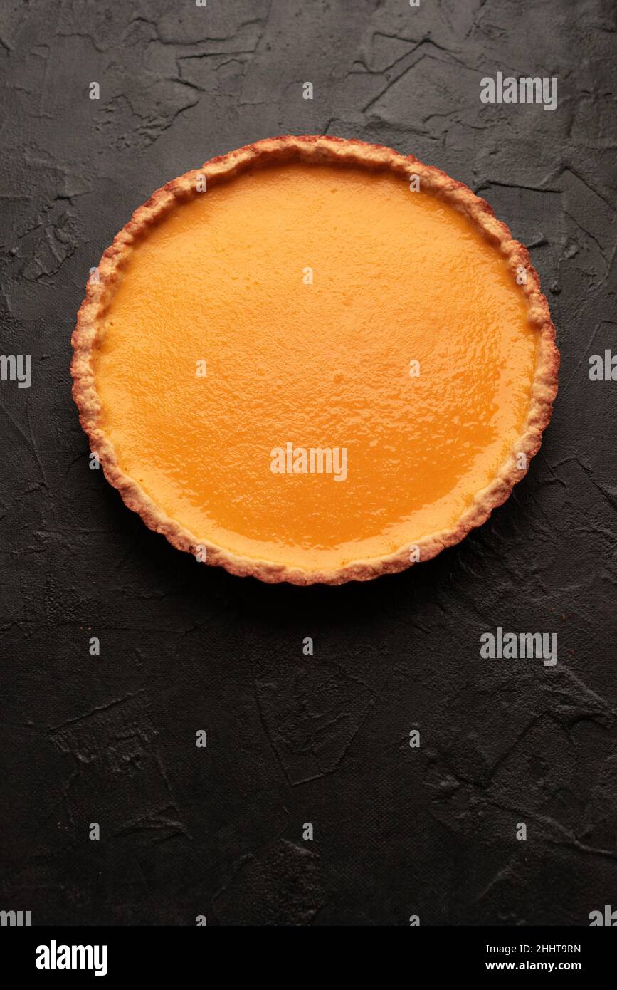Pumpkin pie on dark background overhead view Stock Photo - Alamy