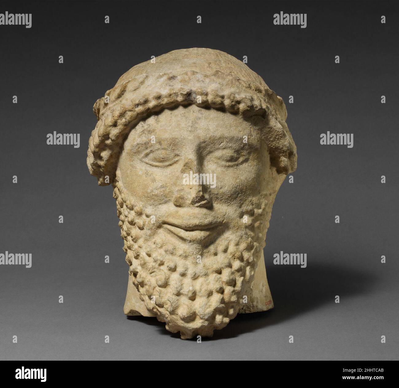 Limestone head of a bearded male with a wreath of leaves 2nd quarter of ...