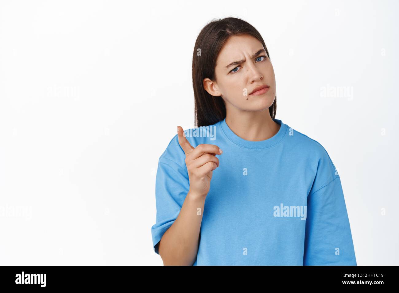 Image of angry young woman shaking finger in disapproval, scolding ...