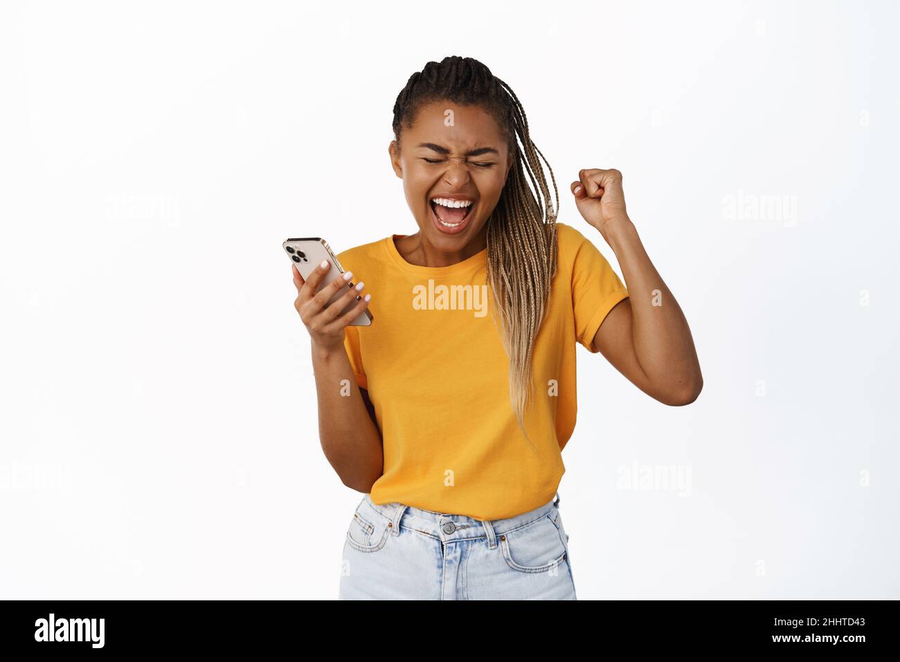 Girl winning on mobile phone, reacting happy to notification, good news ...