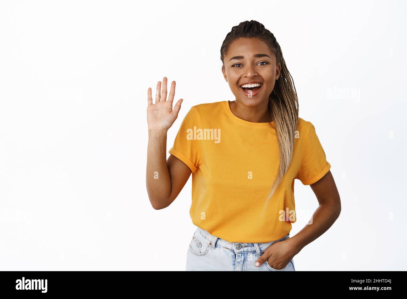 Happy african american woman laughing and smiling, saying hello, waving ...