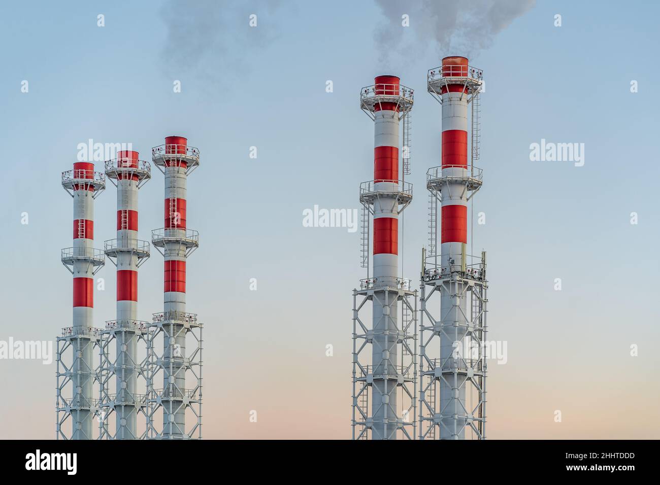 Smoking Chimneys. Factory chimneys with thick smoke against the ...