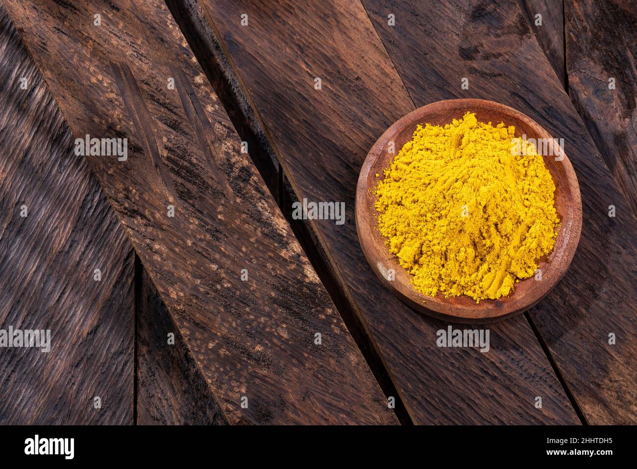 Organic curry yellow powder in the wooden bowl - Organic spice Stock ...