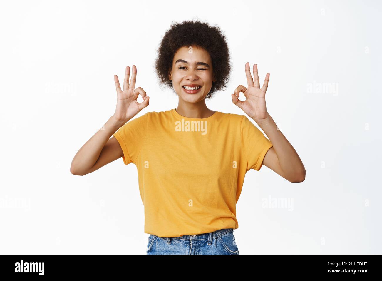 Image of smiling african woman winks and shows, zero, okay signs in ...