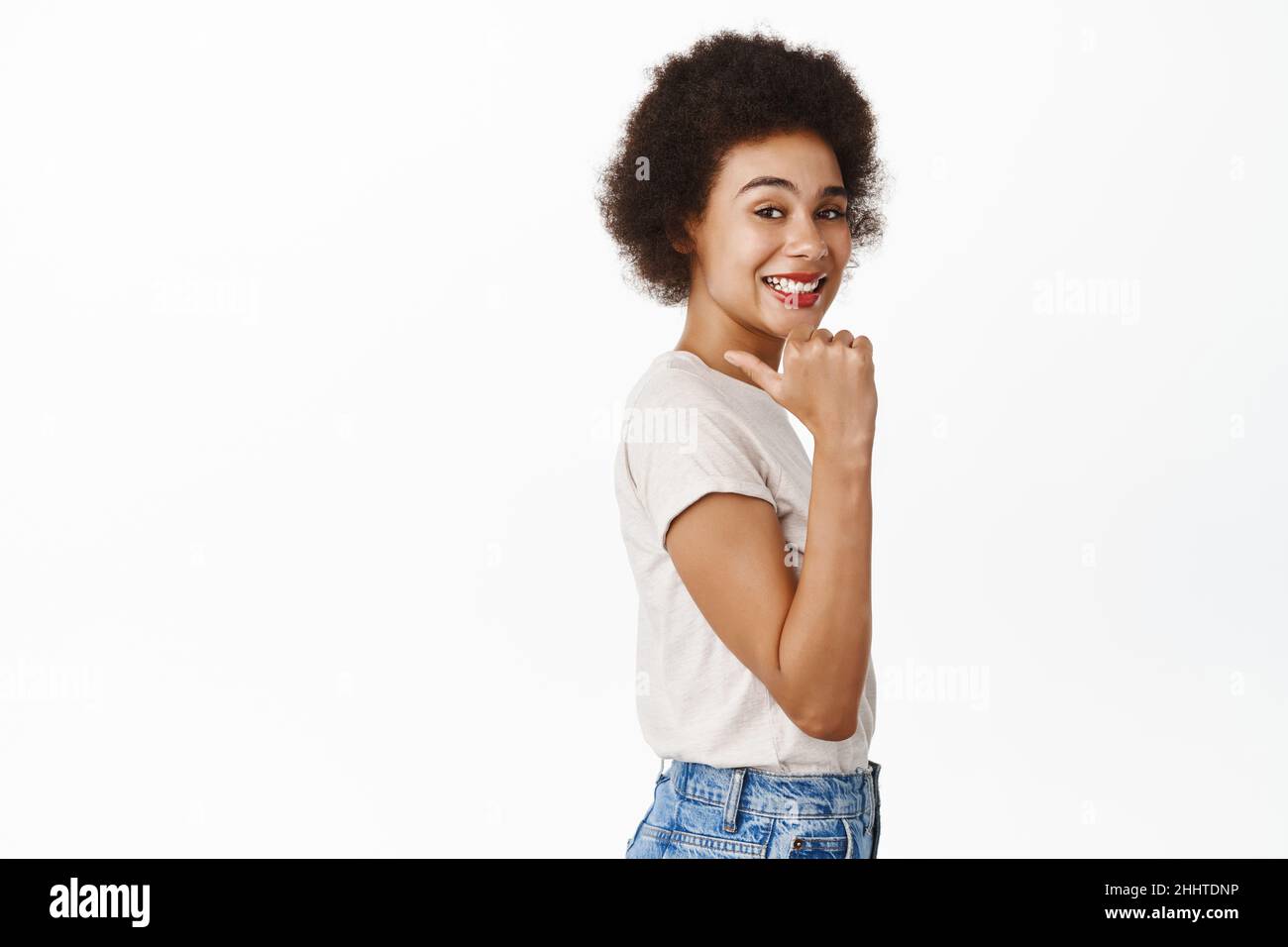 Portrait of smiling teen black woman, student pointing finger left ...