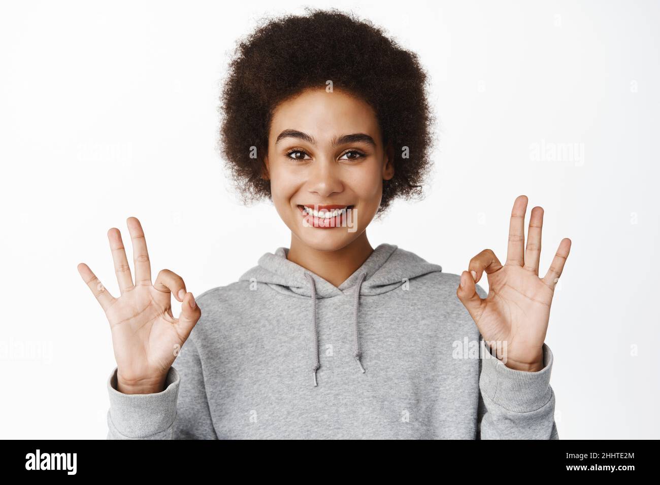Portrait of cheerful black girl showing okay, zero no problem gesture ...