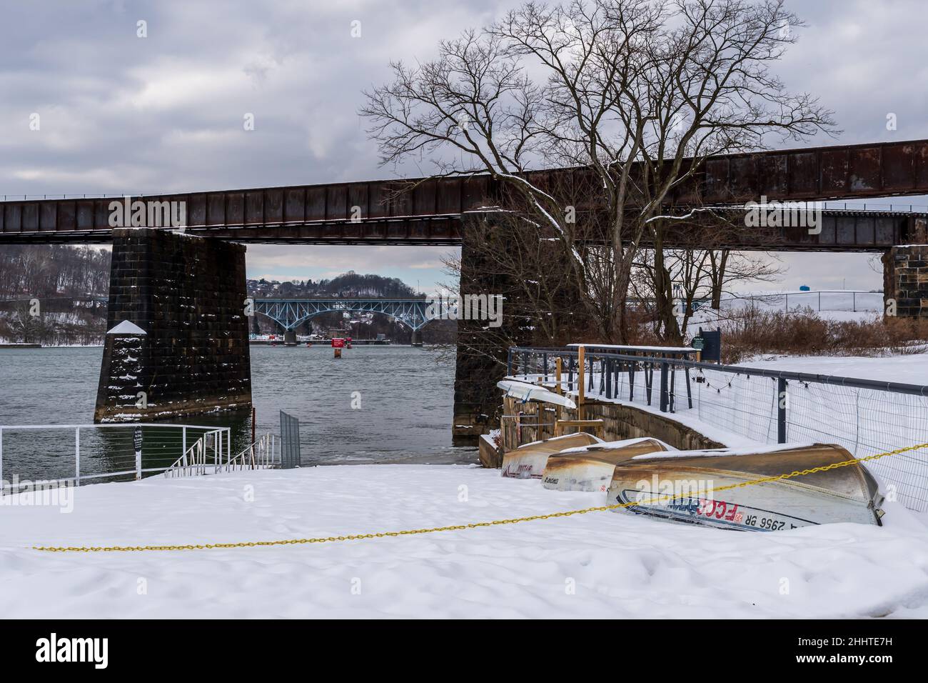A chain closed ramp to the Allegheny River with a train bridge and the ...