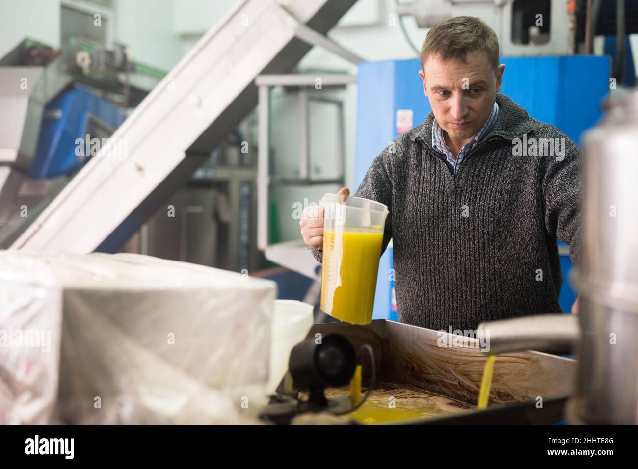 Man controlling process of oil decanting Stock Photo - Alamy