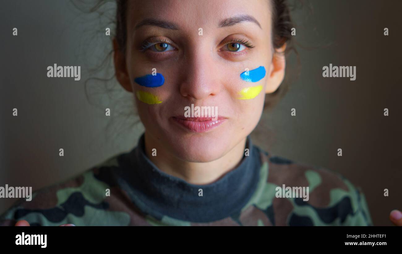 Indoor portrait of young girl with blue and yellow ukrainian flag on ...