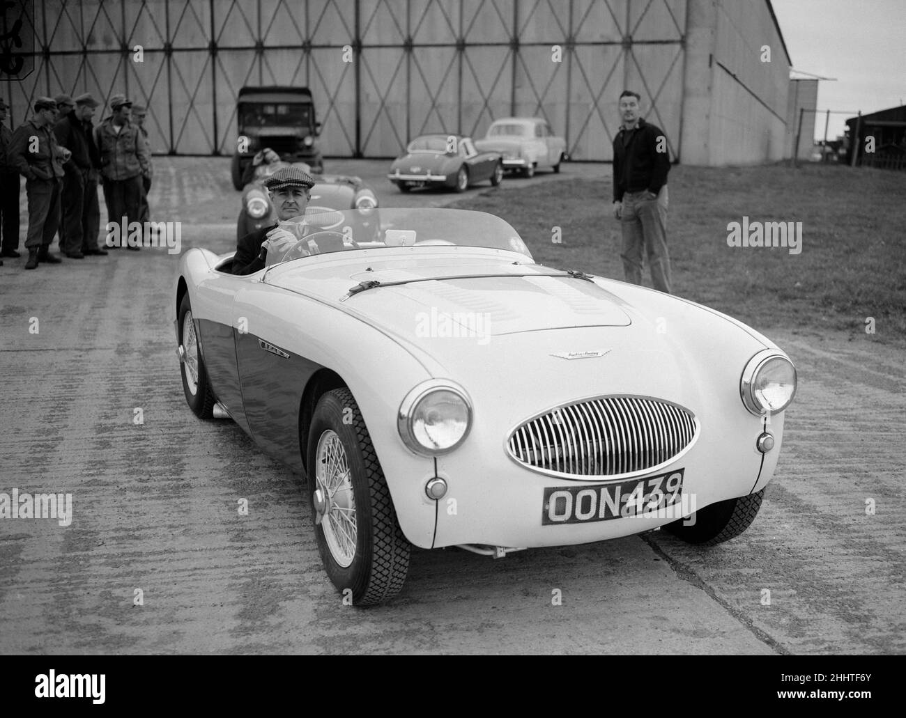 Daily Herald motor racing correspondent Thomas H Wisdom sitting at the ...