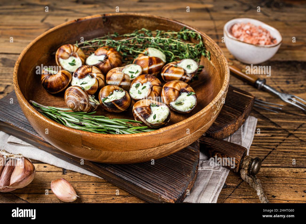 French Escargot Snails with garlic butter in a wooden plate. Wooden ...