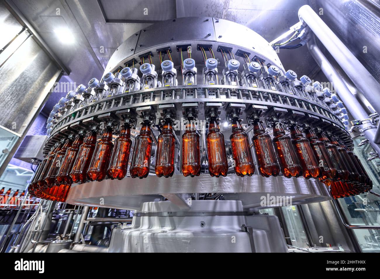 Filling plastic bottles with various drinks on an automatic filling ...