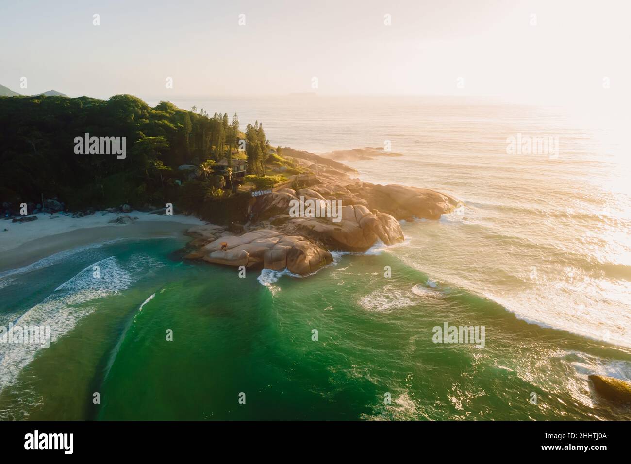 Joaquina Beach with rocks and ocean with waves at sunrise in Brazil ...