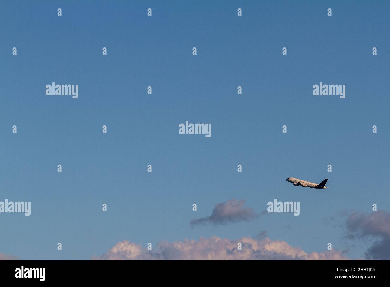 A plane is taking off in the blue sky Stock Photo - Alamy