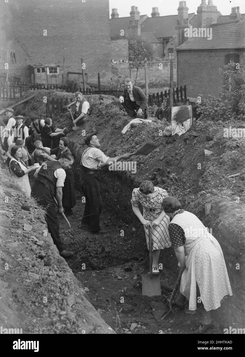 Eastenders seen here digging a trench for a communal air raid shelter ...
