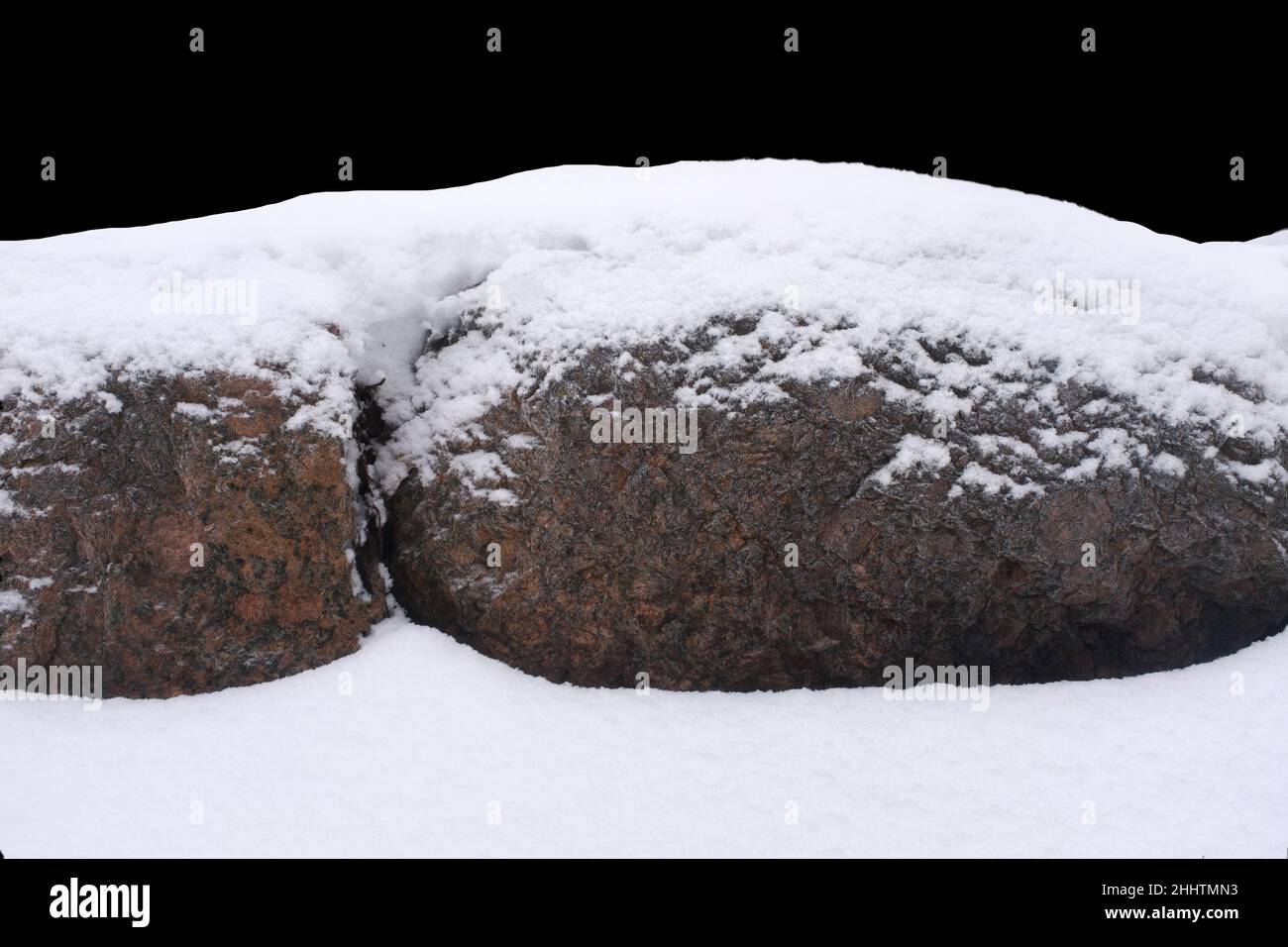 natural stone in snow isolated on black background Stock Photo - Alamy