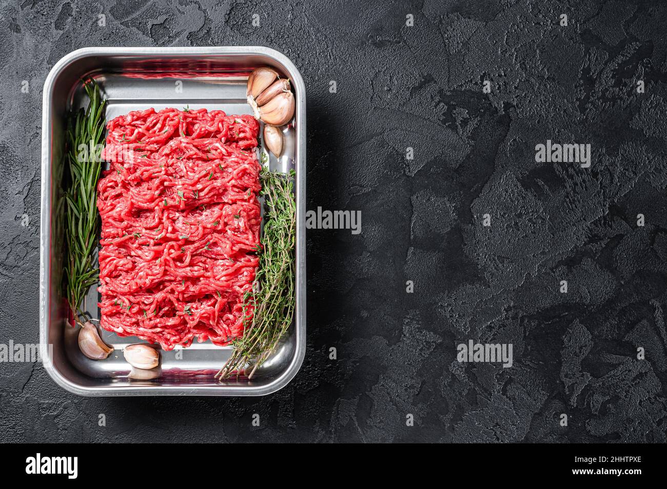 Raw beef Forcemeat, ground meat. Black background. Top view. Copy space ...