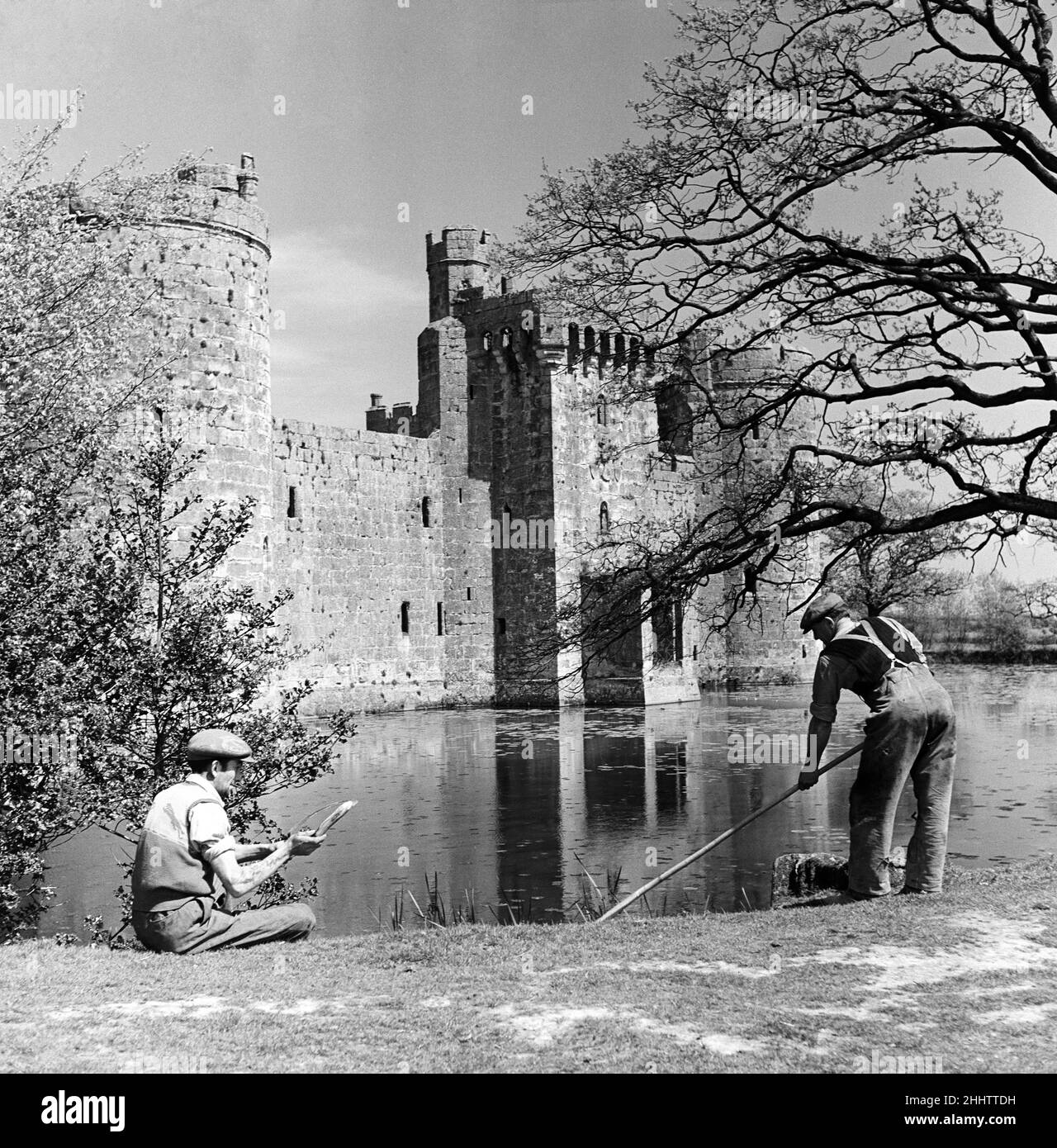 A groundkeeper cleaning the moat outside Bodiam Castle, a 14th-century ...