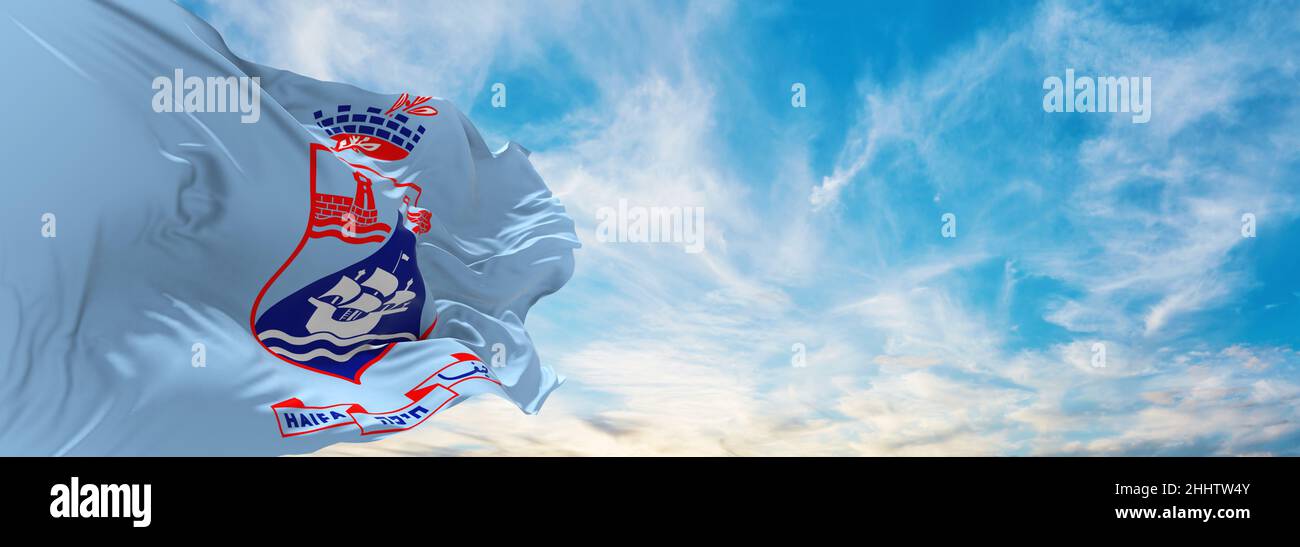 flag of Haifa , Israel at cloudy sky background on sunset, panoramic ...