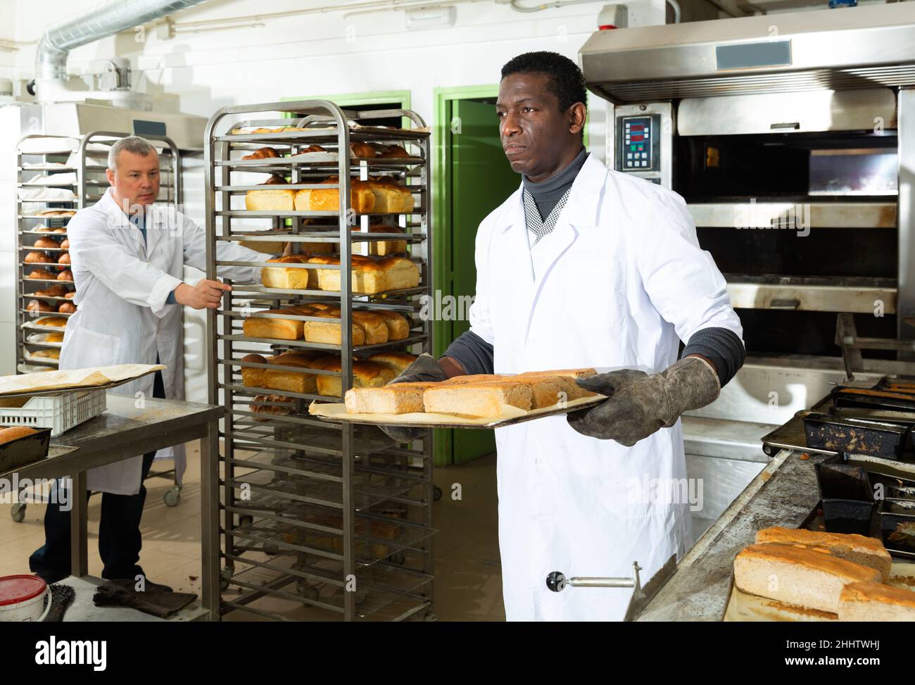 African baker carrying baked bread on tray Stock Photo - Alamy