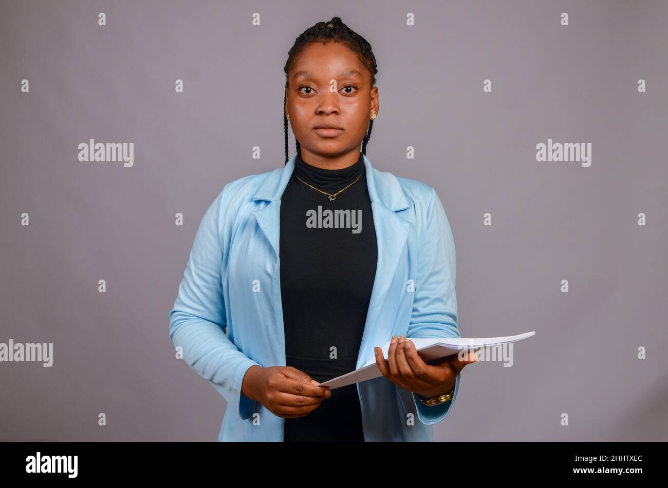 close up of a beautiful african lady in focused holding file Stock ...