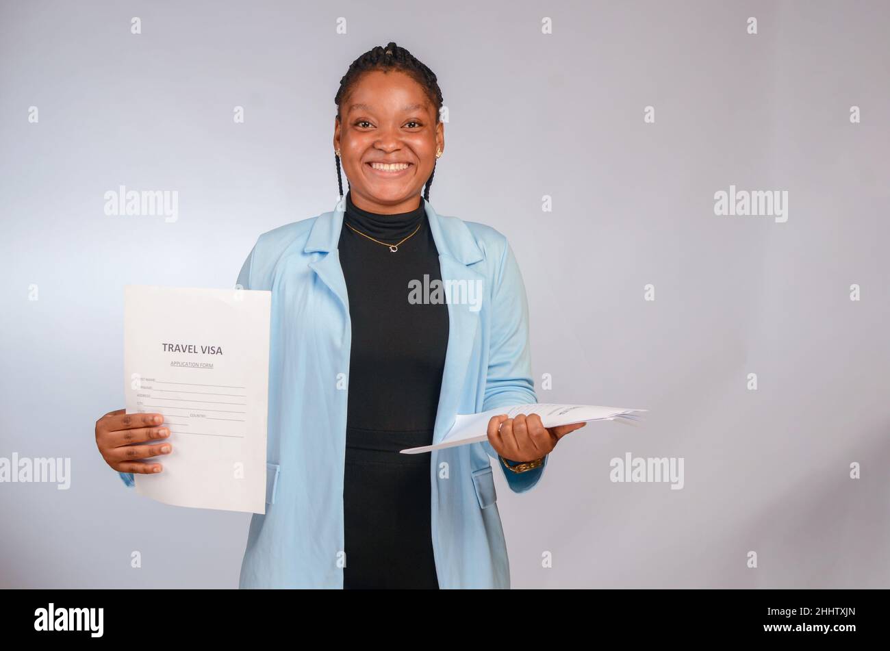close up of a beautiful african black travel agent holding travel visa ...