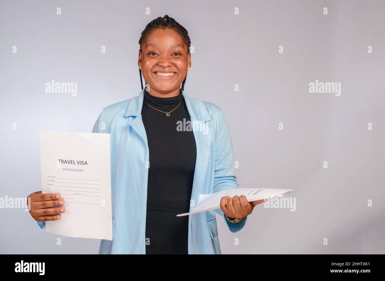 close up of a beautiful african black travel agent holding travel visa ...