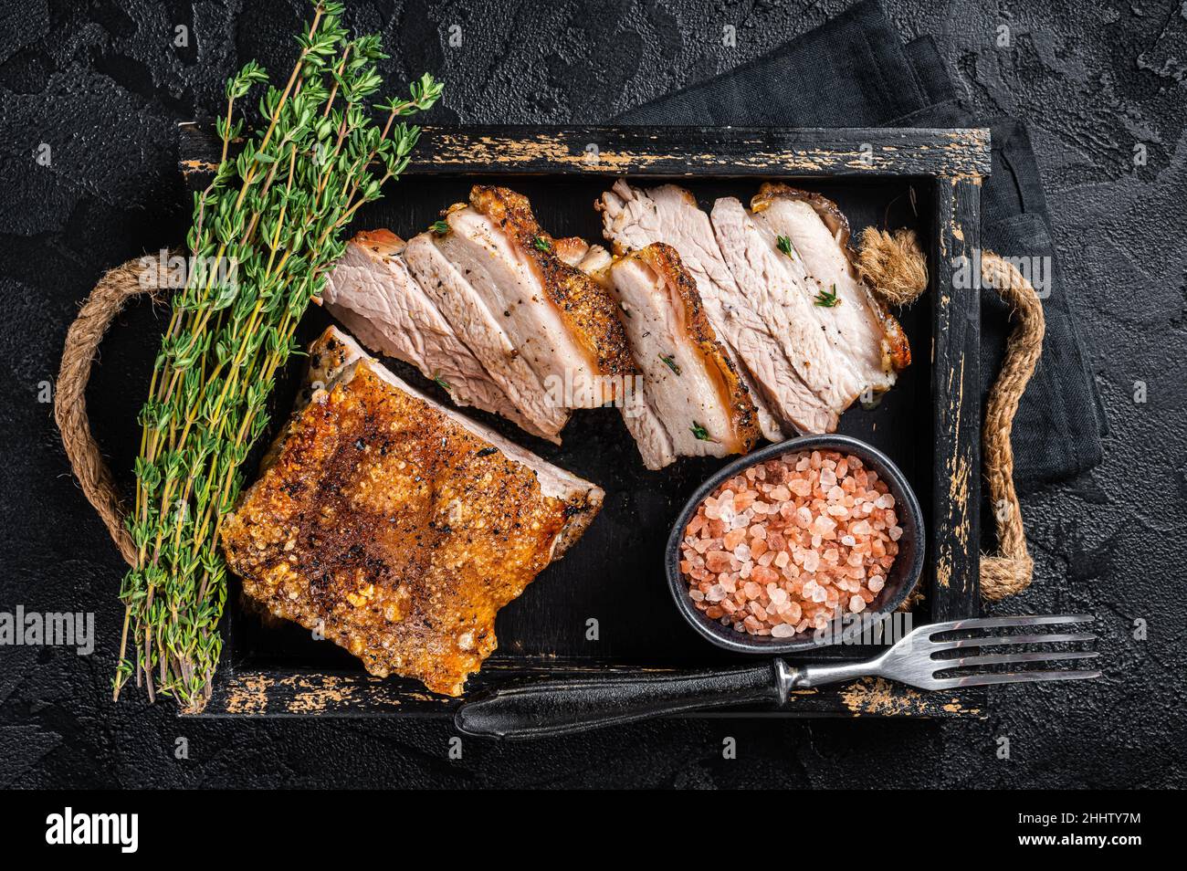 Crispy Roast Pork Belly. Sliced roasted meat with crust in a tray with ...