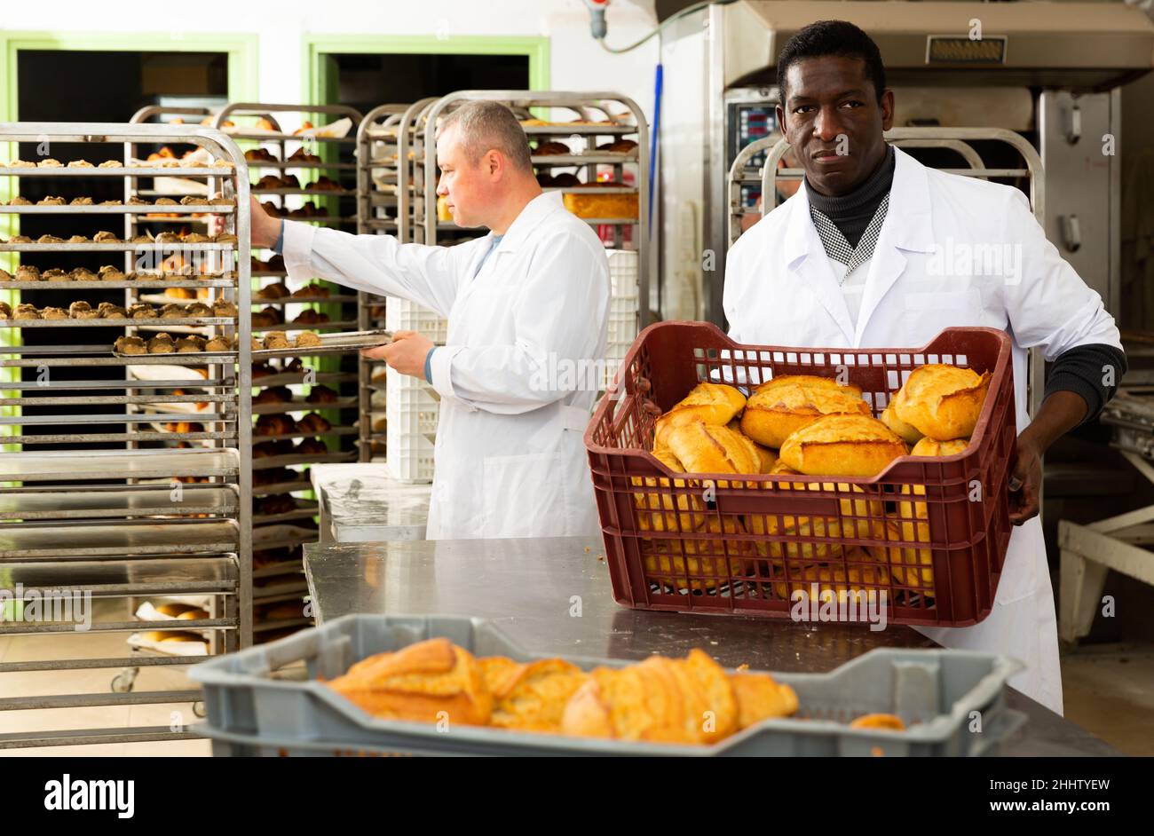 Bakers working in bakehouse Stock Photo - Alamy