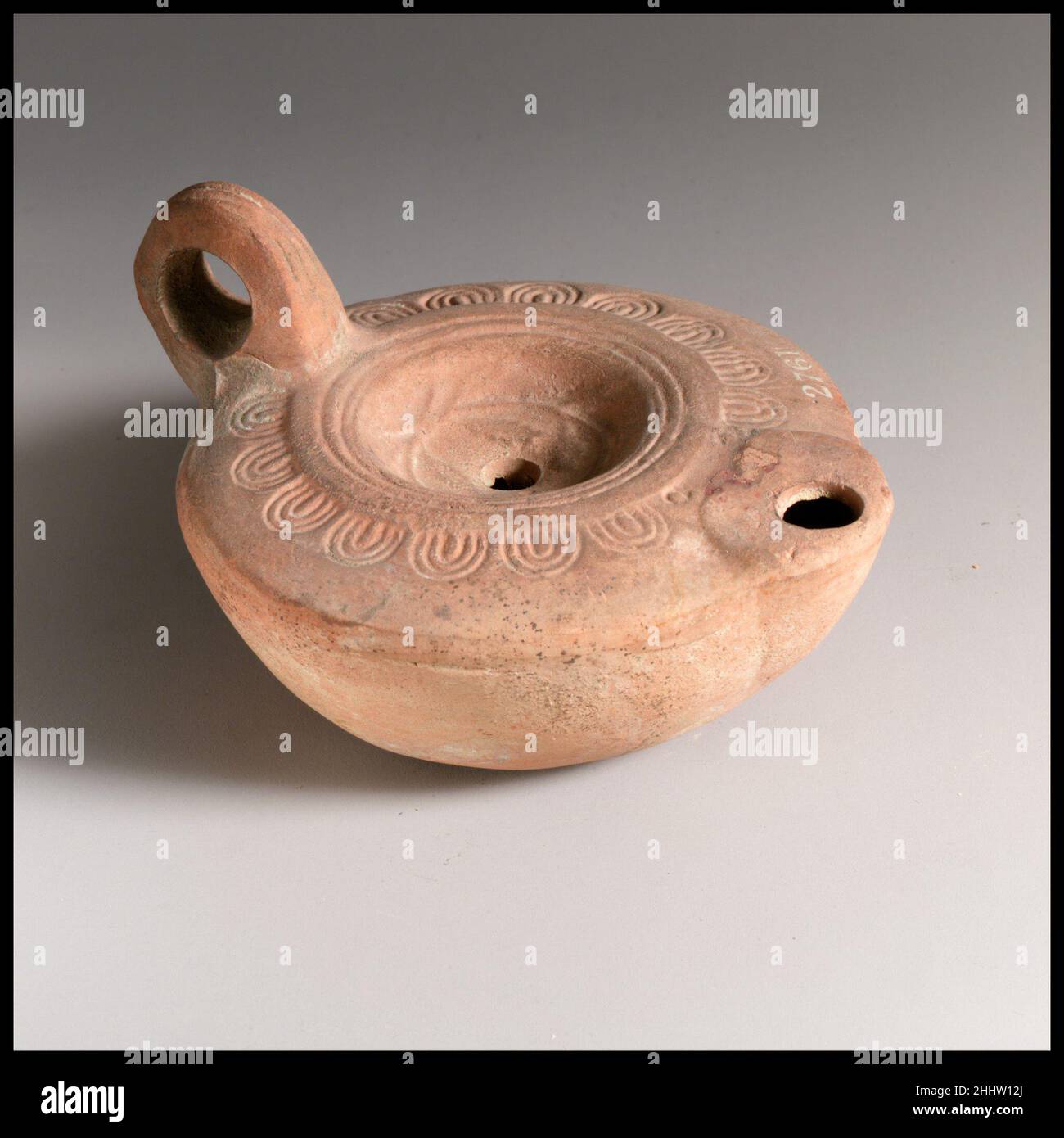 Terracotta oil lamp 2nd century A.D. Roman Mold-made, with ring handle ...