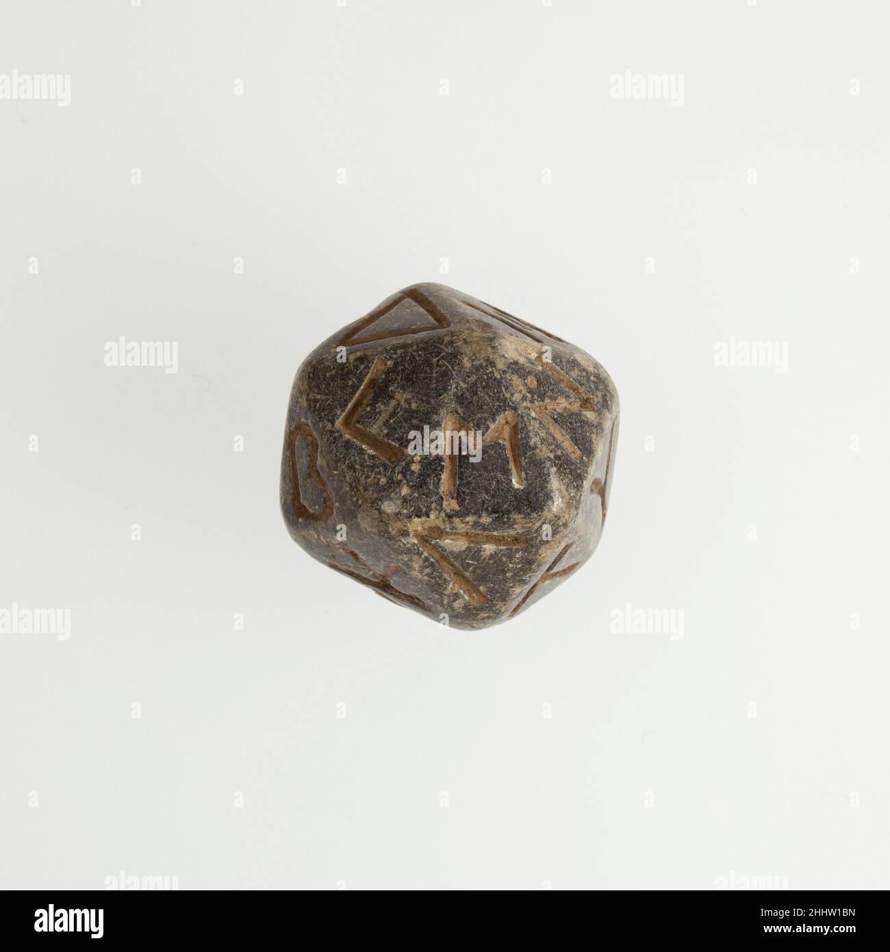 Twenty-sided die (icosahedron) with faces inscribed with Greek letters ...