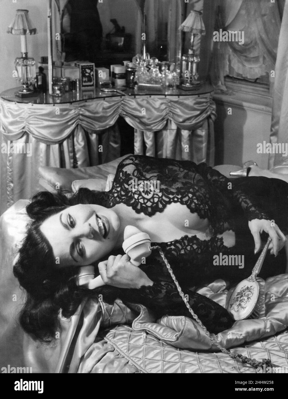 Simone Silva, french actress, answers the telephone in her boudoir, at ...