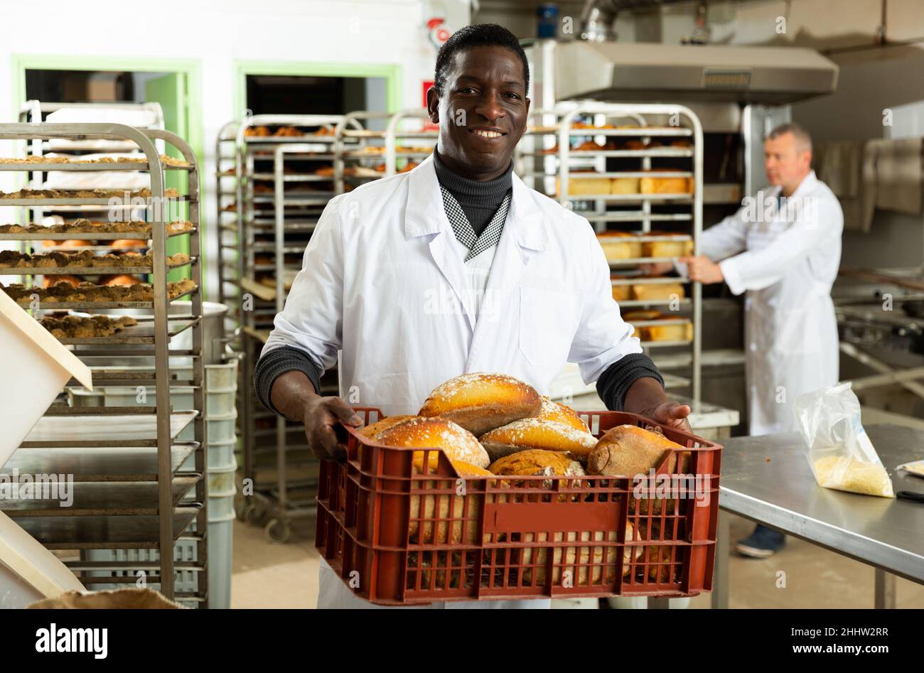 African baker carrying box with baked bread Stock Photo - Alamy