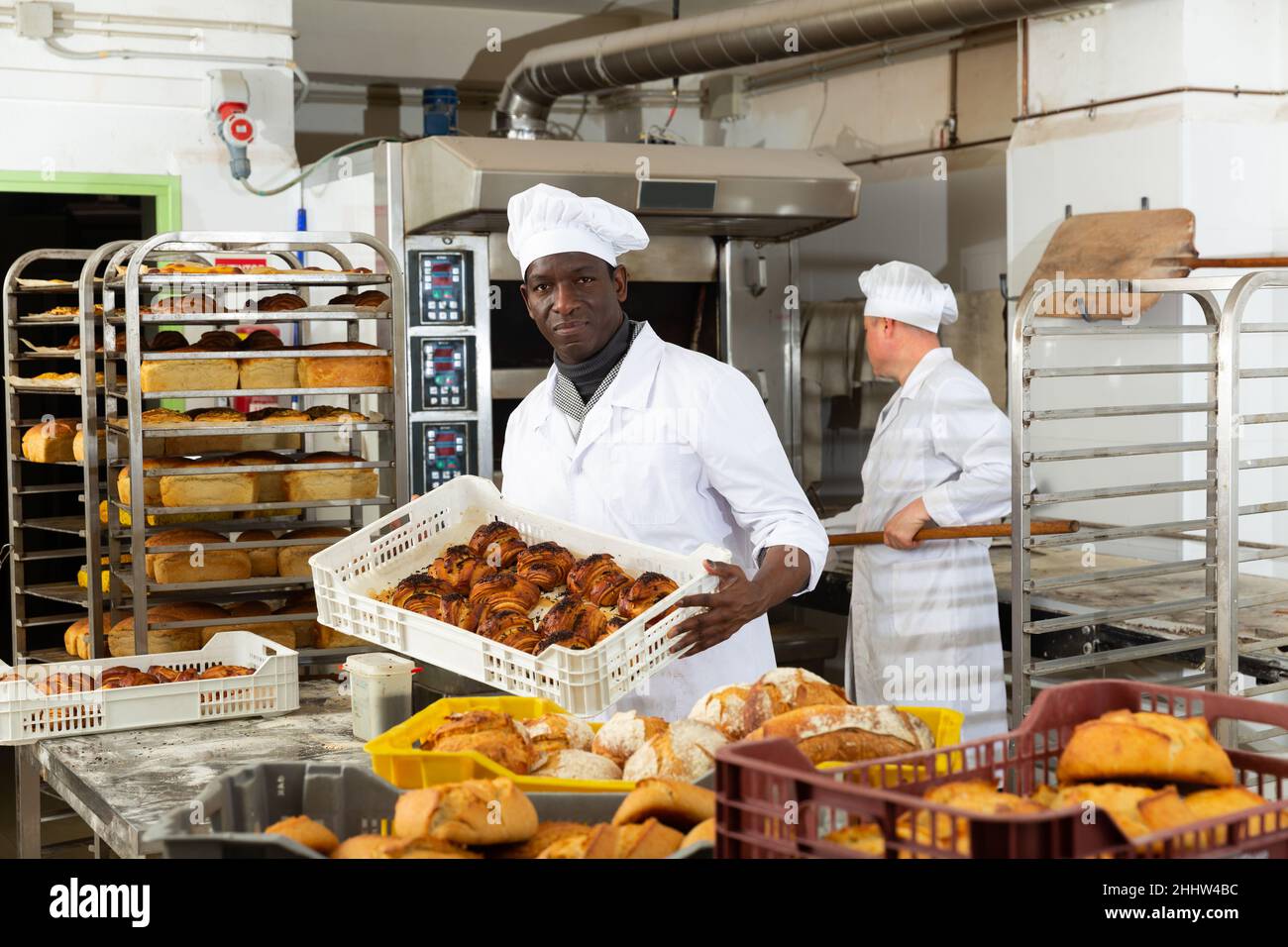 African baker carrying box with baked bread Stock Photo - Alamy
