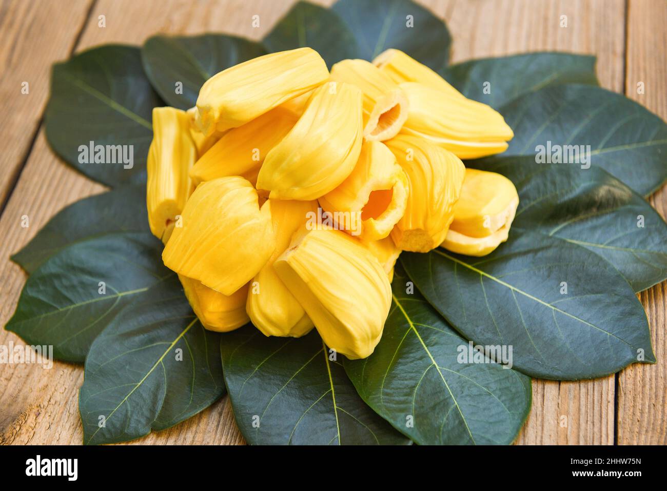 jackfruit on green leaf on the wooden table background, ripe jackfruit ...