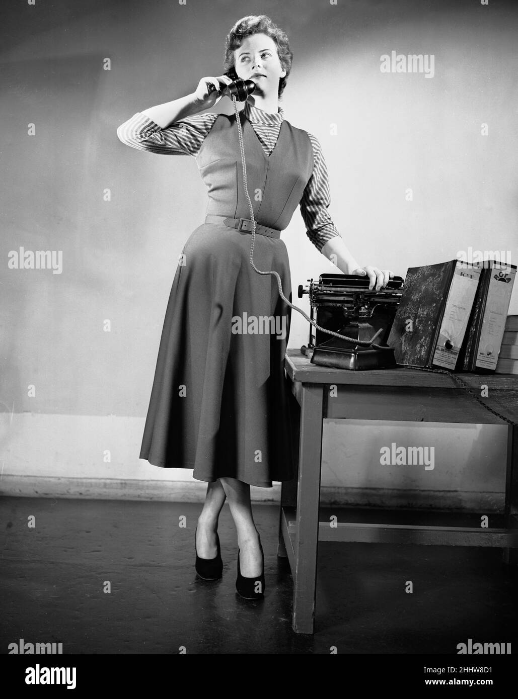 A secretary talking on the telephone in the office.June 1952 Stock ...