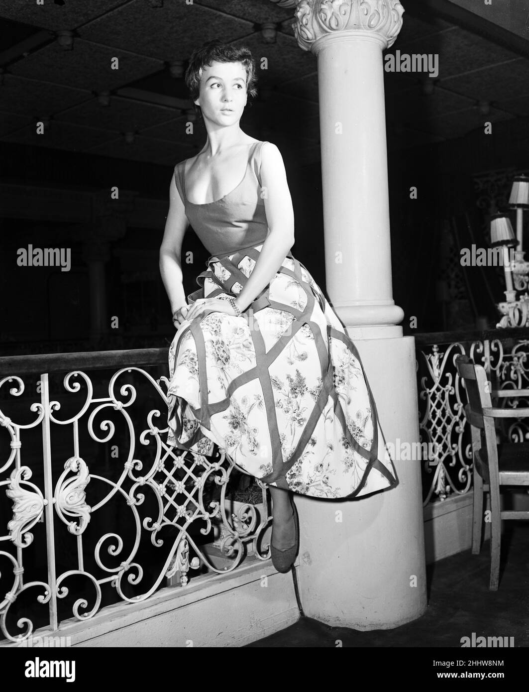 Model, Guislaine, pictured wearing a bold swoop neckline dress designed ...