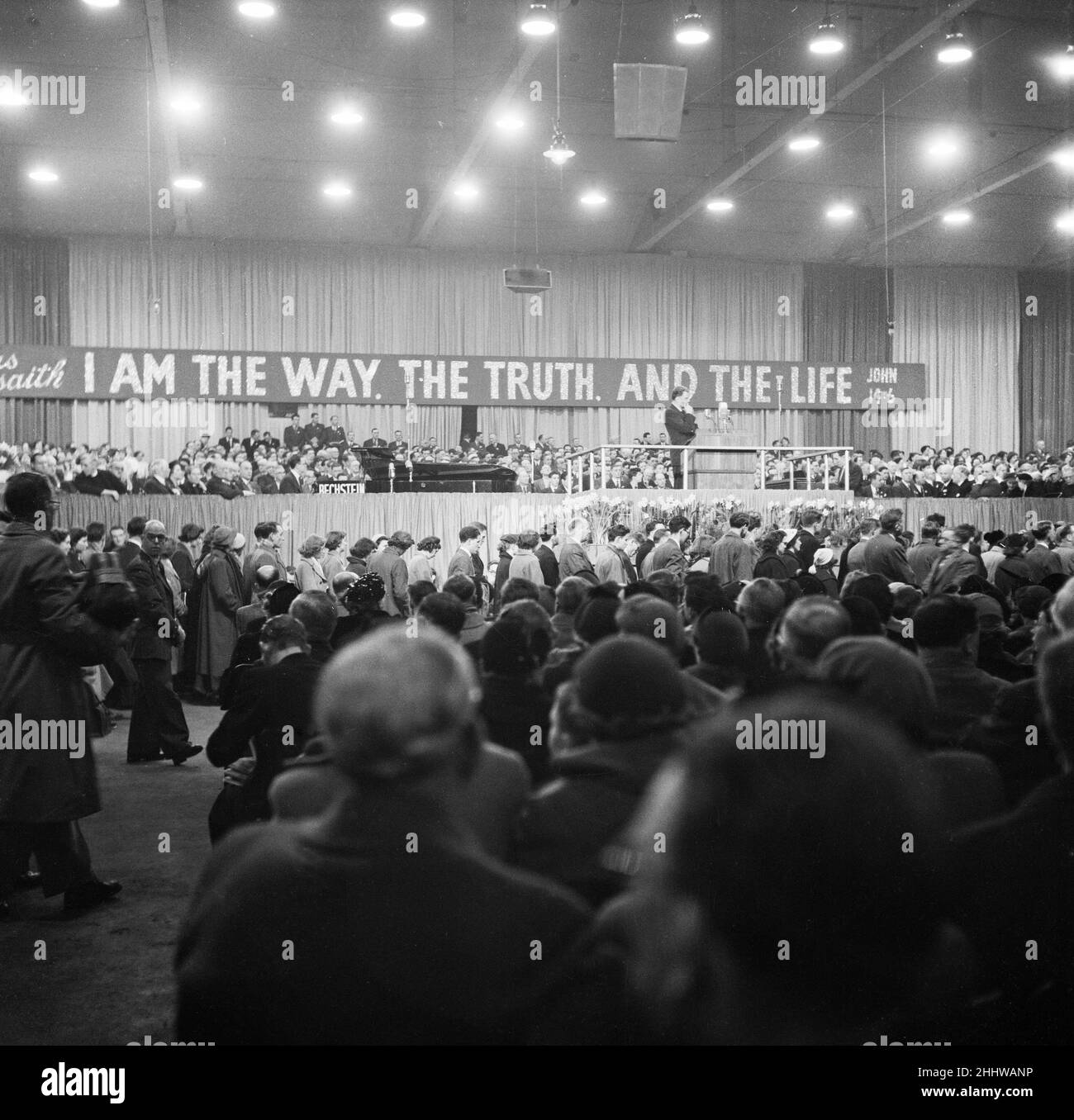 American evangelist Billy Graham addressing a huge crowd of people at ...