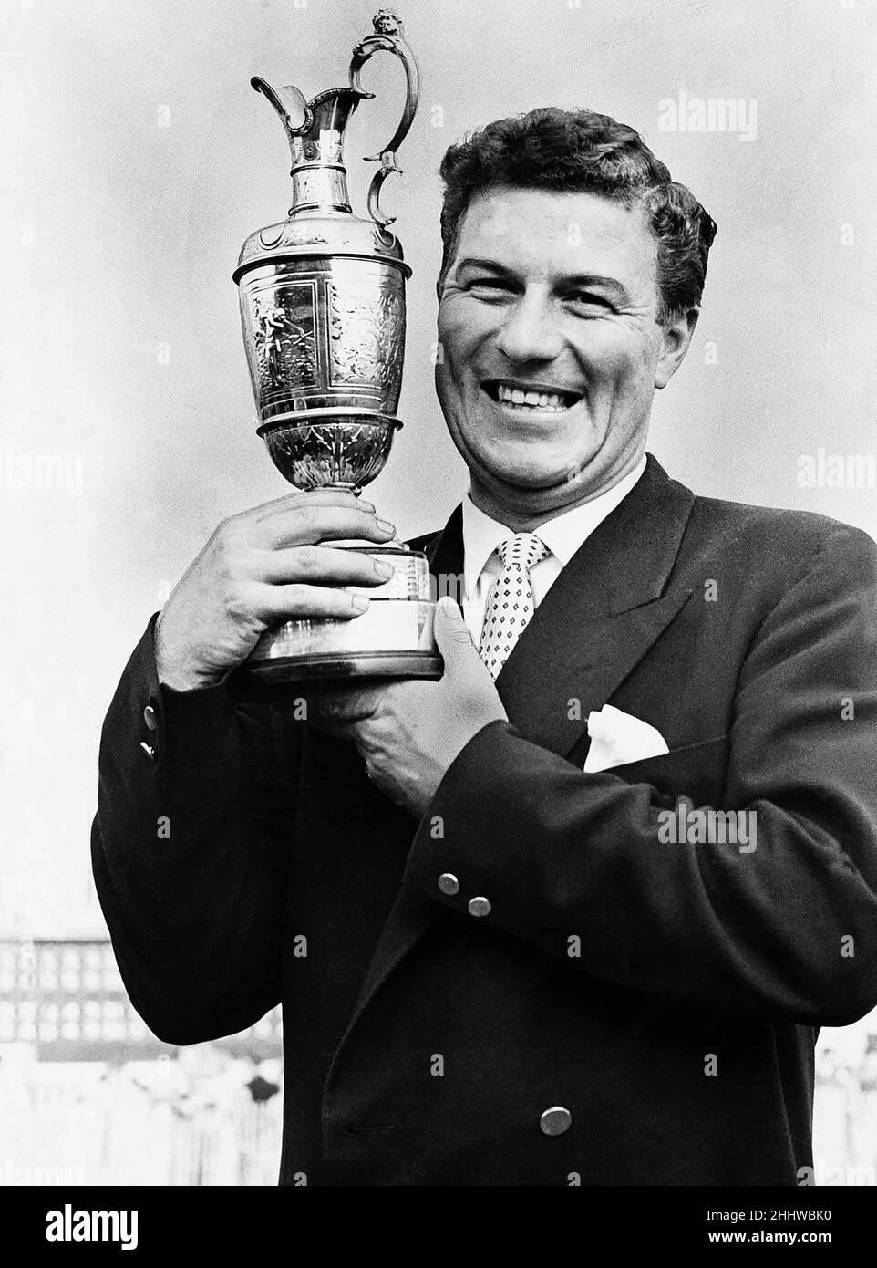 Golfer Peter Thomson holding a trophy wearing a blazer and tie Circa ...