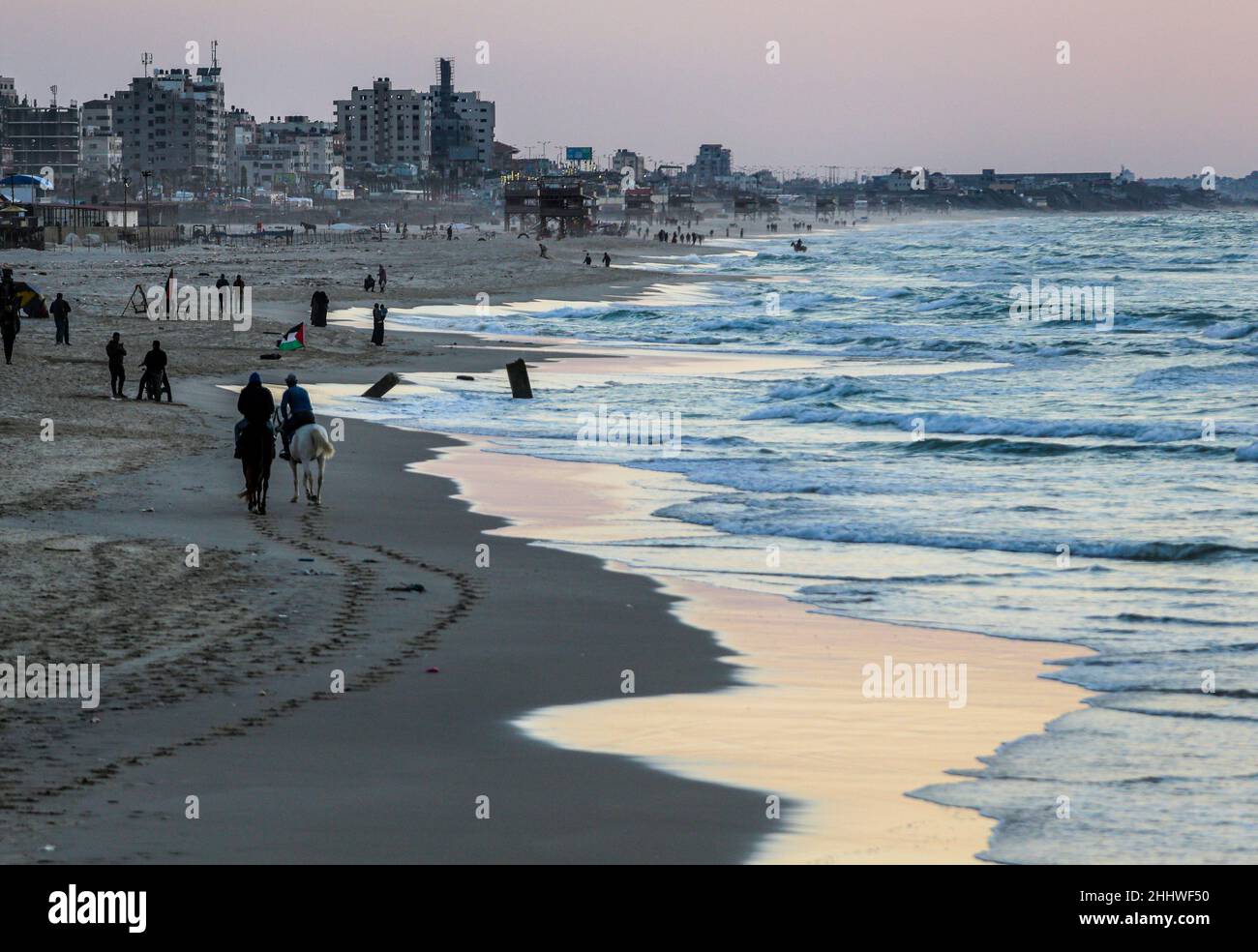 Palestinians enjoy the seashore during sunset in west of Gaza City ...