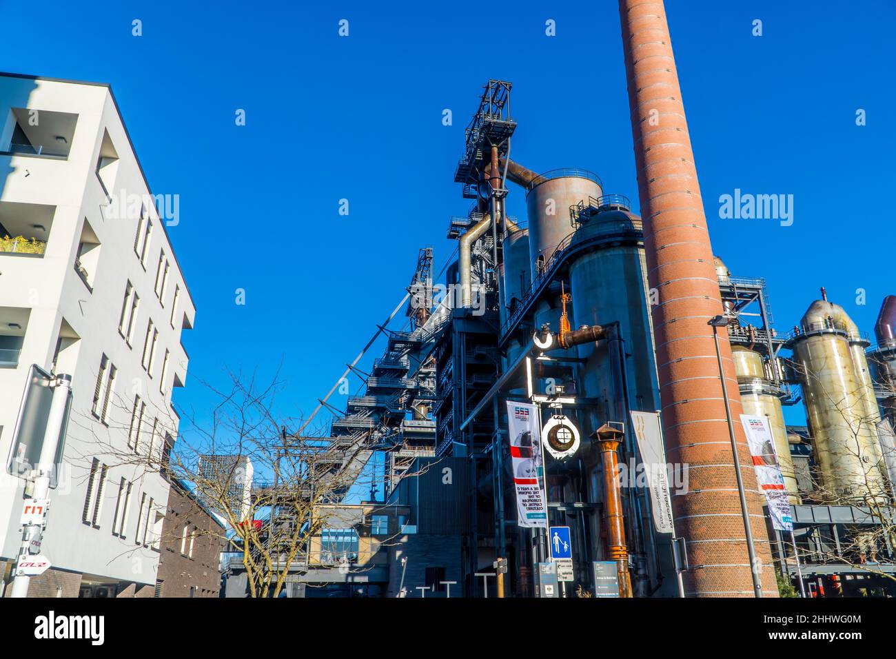 Low angle shot of an old reconverted steel tower chimney and modern ...