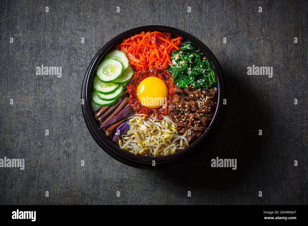Bibimbap Korean Style rice dish. Bowl of warm white rice topped with ...