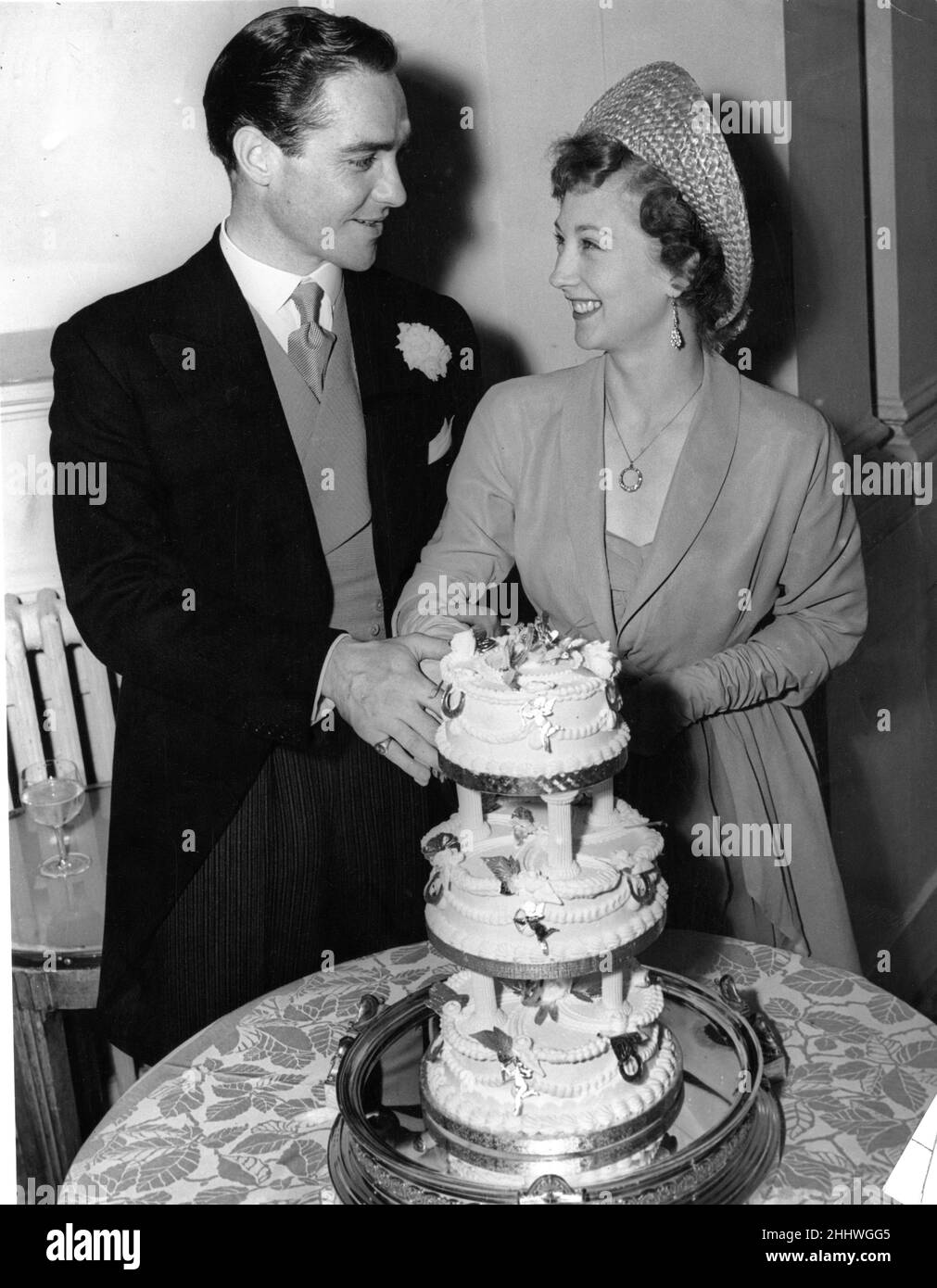 Actor Richard Todd with his bride Catherine Bogle cutting the cake on ...